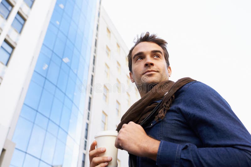 Coffee on the Run. Low Angle Shot of a Handsome Man Drinking a Coffee ...