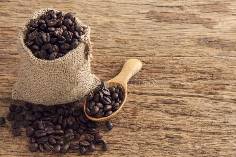 Coffee Seeds in Sack and Spoon on Top Wooden Table. Stock Photo - Image ...