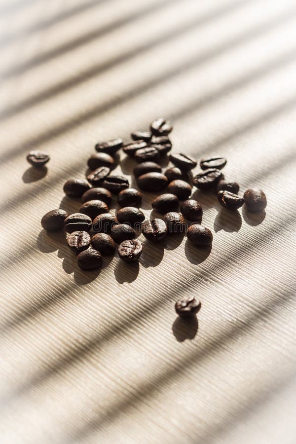 Coffee Seeds on White Table with Shadows from the Blinds Stock Photo ...