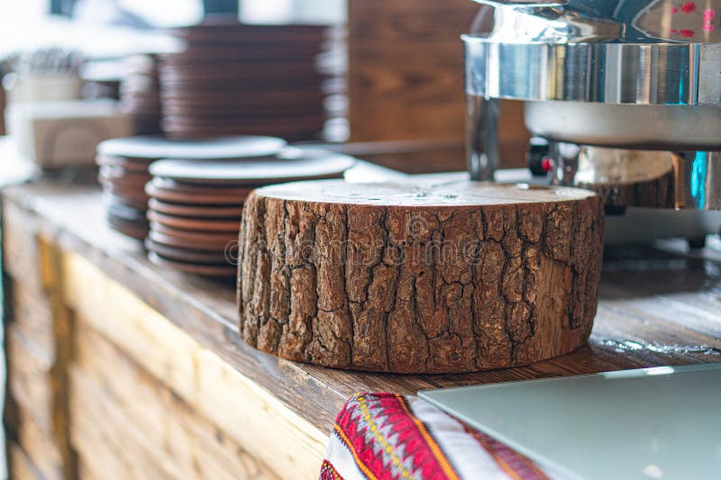 A Coffee Shop with Rustic Design, Featuring a Log Table and Cups on ...