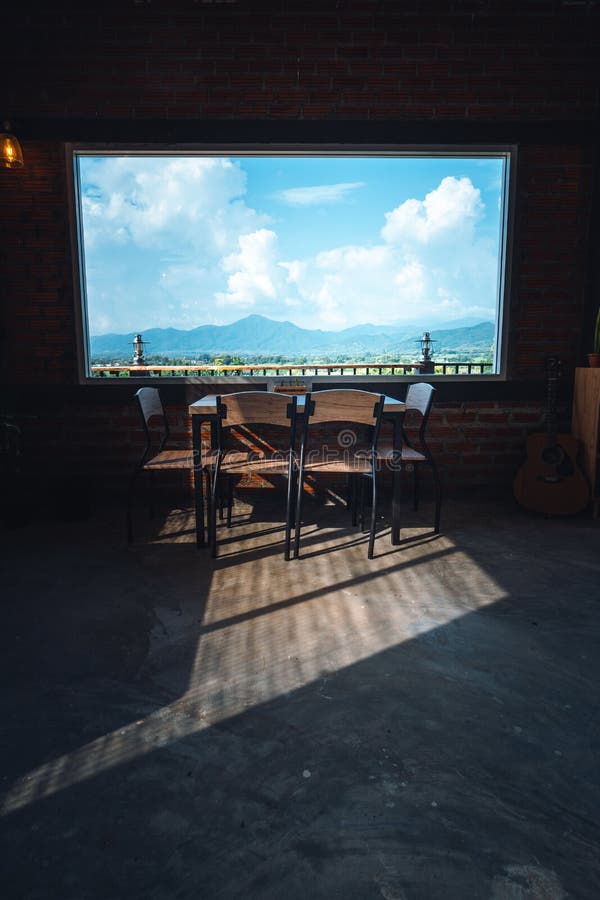 In a Coffee Shop, a Table and a Large Window View the Mountains Stock ...