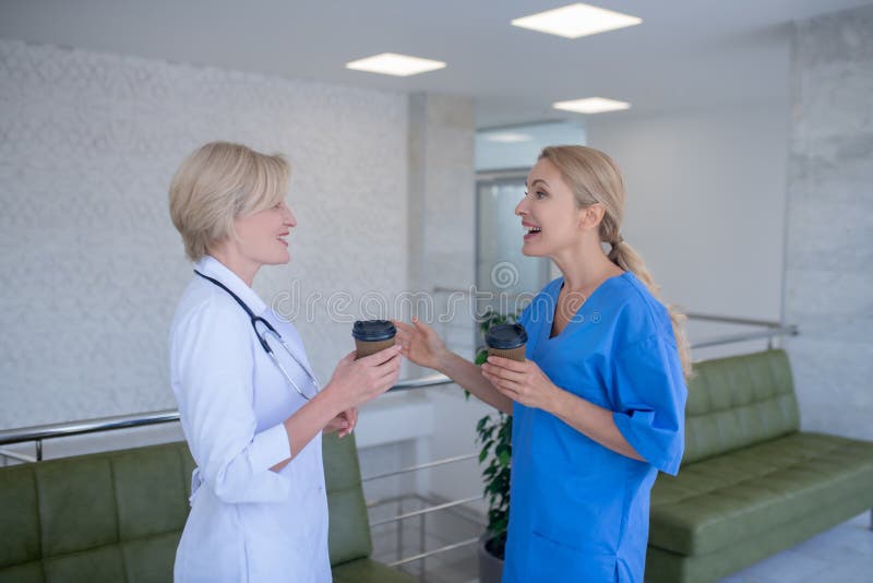 Two Female Medical Workers Having Coffee, Talking Stock Photo - Image ...