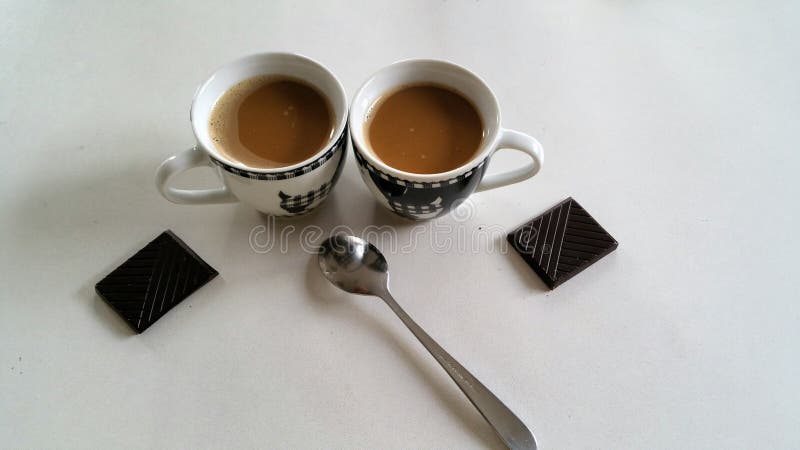 Coffee in Two Small Cups with Spoon and Chocolate on the Side Stock ...