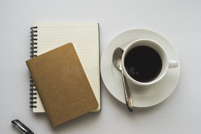 Coffee in White Cup with Journal Book and Pencil Stock Image - Image of ...