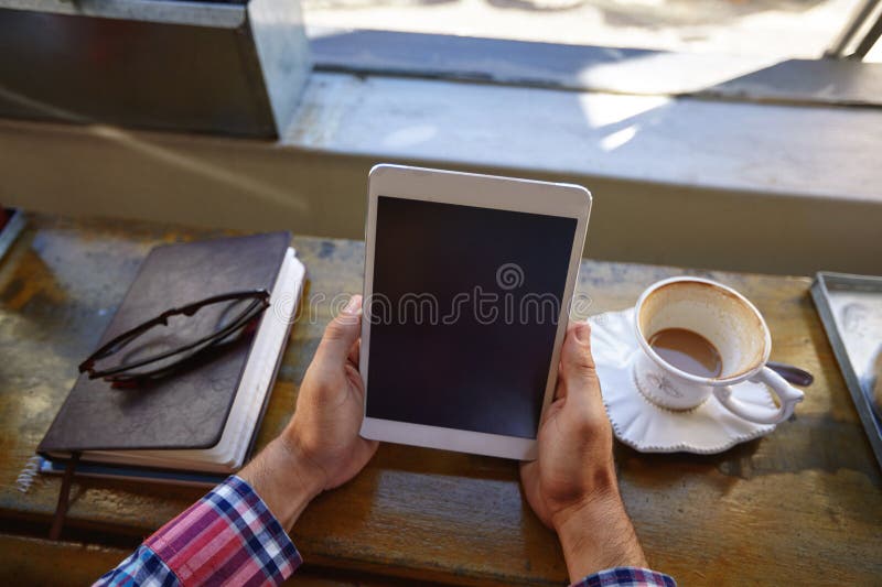 Coffee and Wireless Freedom. a Man Using a Digital Tablet at a Cafe ...
