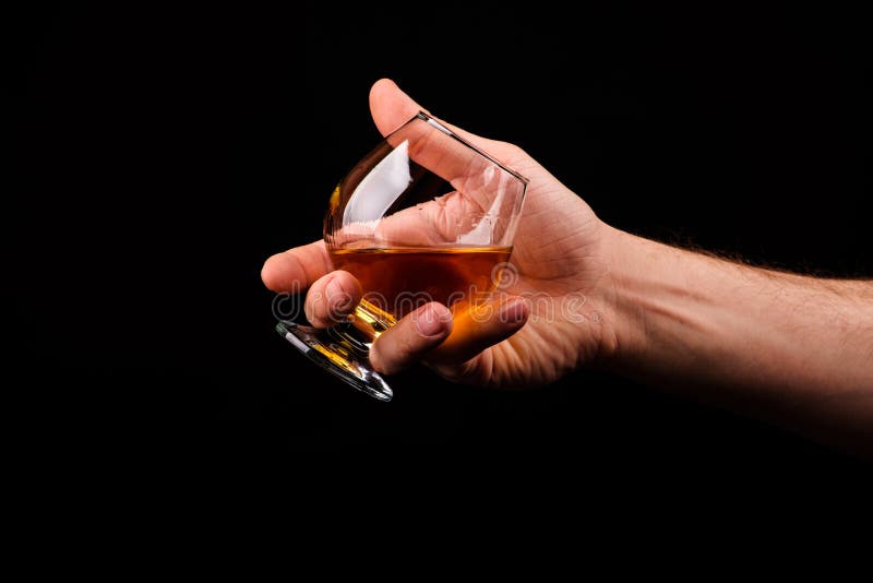 Cognac Glass in a Hand of a Man Stock Photo - Image of liqueur, black ...