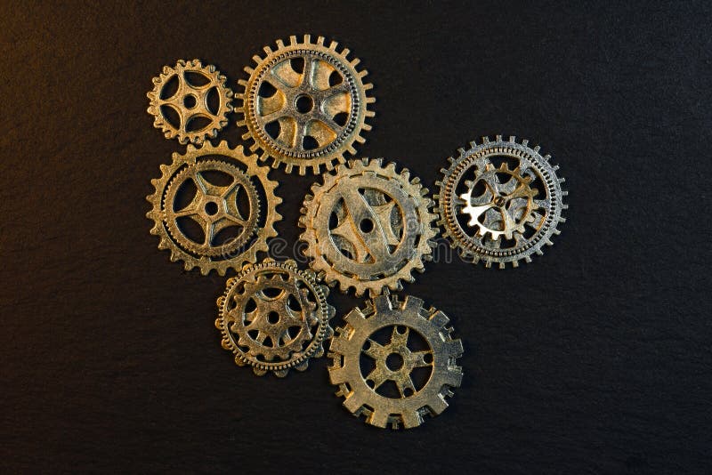 Cogs and Gear Wheels Arranged on Slate Rock Background Showing Textures ...
