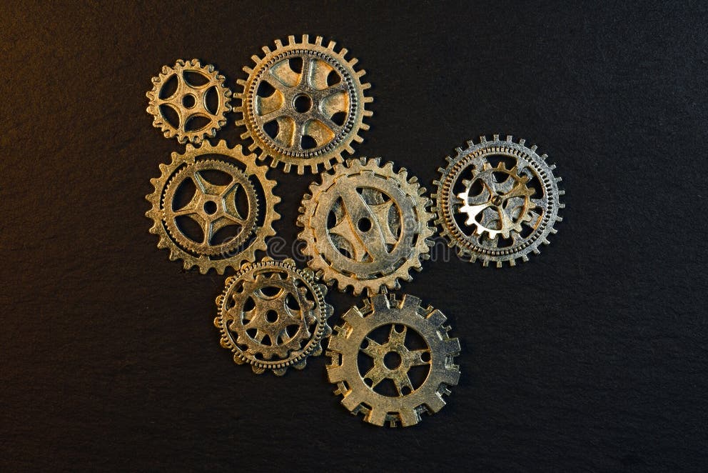 Cogs and Gear Wheels Arranged on Slate Rock Background Showing Textures ...