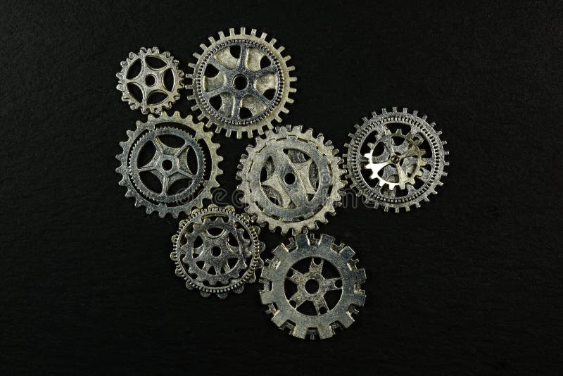 Cogs and Gear Wheels Arranged on Slate Rock Background Showing Textures ...