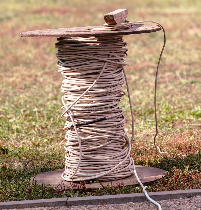 A Coil of Electrical Wire Stands on the Ground in the Park Stock Photo ...