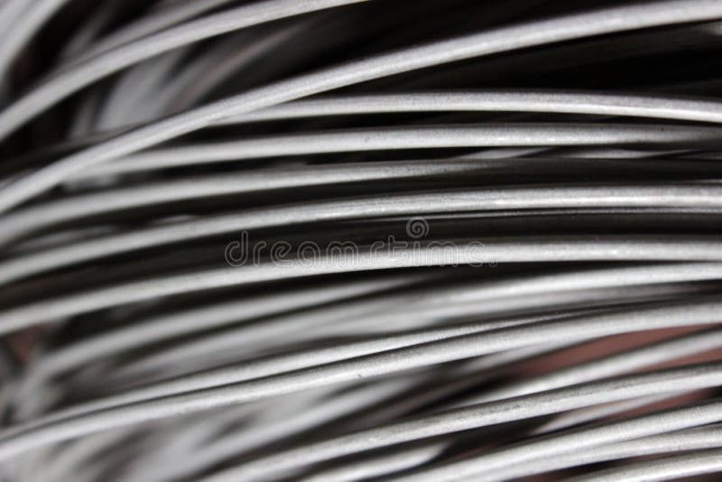 A Coil of Fechral Thick Refractory Wire Hangs in a Warehouse of Goods ...
