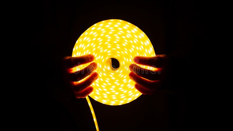 Coil of Glowing LED Strip with Warm Light in Hand Stock Photo - Image ...