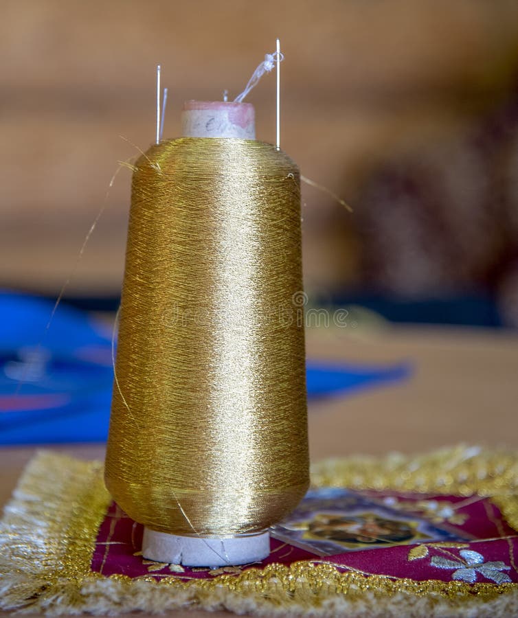 A Coil of Gold Thread Stands on the Table. the Coil is Inserted the ...