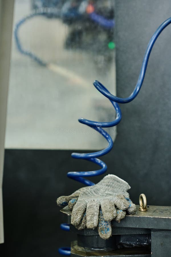 Coiled Blue Spring with Work Gloves in Workshop Setting Stock Image ...