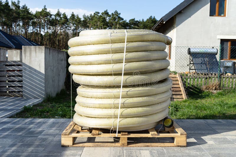 Coiled Drainage Pipe Lying on a Pallet in the Yard. Stock Photo - Image ...