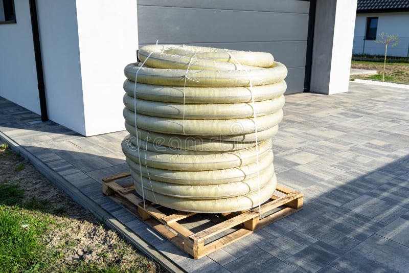 Coiled Drainage Pipe Lying on a Pallet in the Yard. Stock Image - Image ...