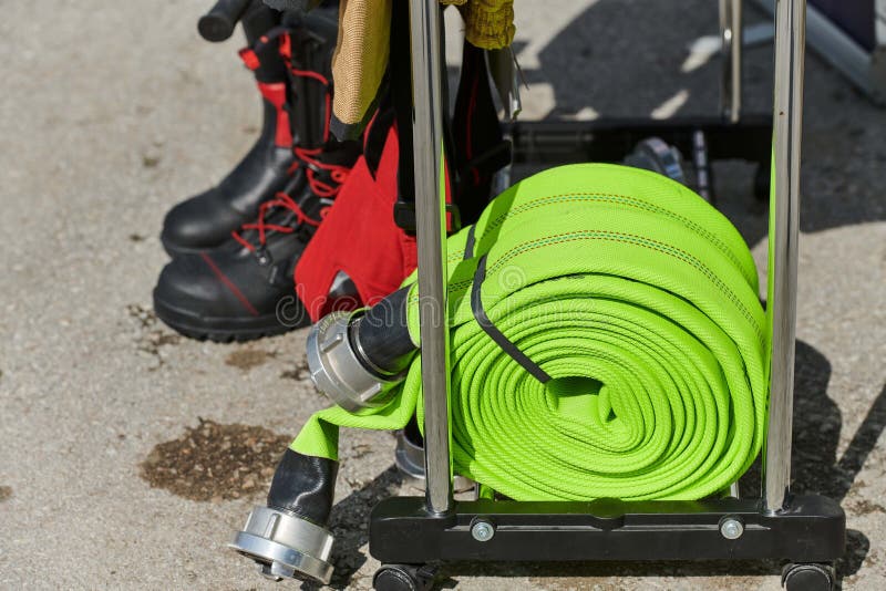 Coiled Fire Hose Ready for Action on the Ground Stock Image - Image of ...