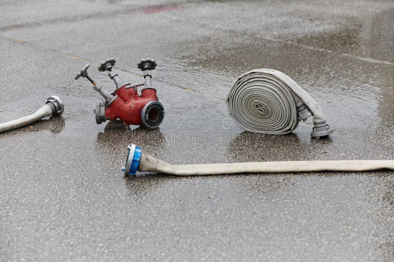 Coiled Fire Hose Ready for Action on the Ground Stock Image - Image of ...