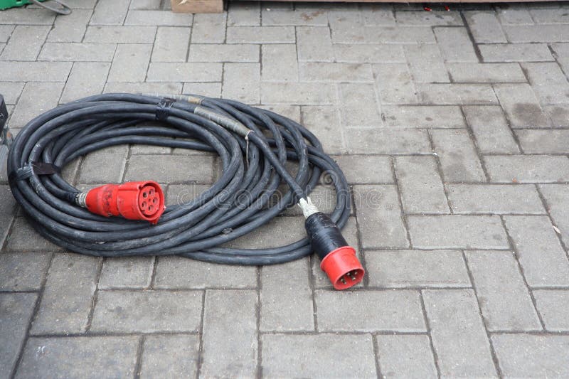 Coiled Electrical Extension Cord Sitting on a Paved Surface for ...