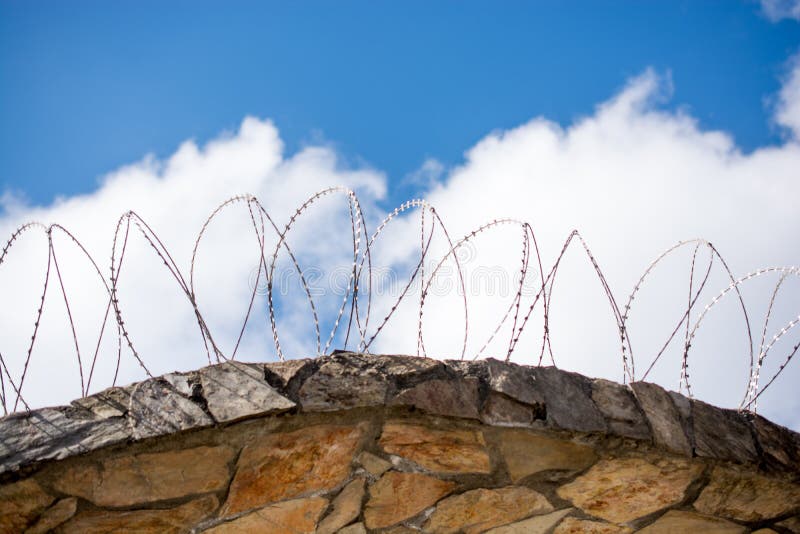 Coiled Razor Wire on Top of a Fence Stock Image - Image of access ...