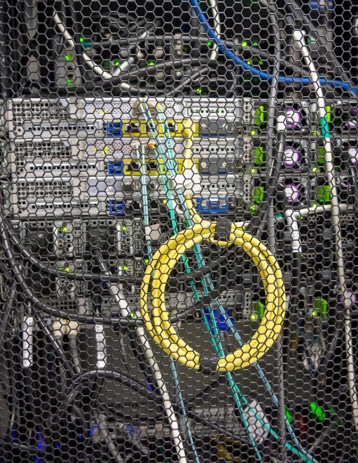 Coiled Yellow Cable Connecting Digital Equipmnet Installed in a Rack ...