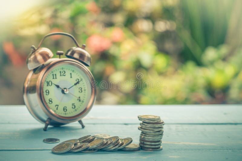 Coin Stack on Wood with Alarm Clock Stock Image - Image of financial ...
