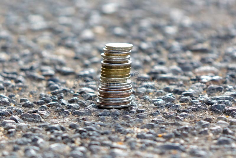 Coins on the asphalt road stock photo. Image of bank - 179371934