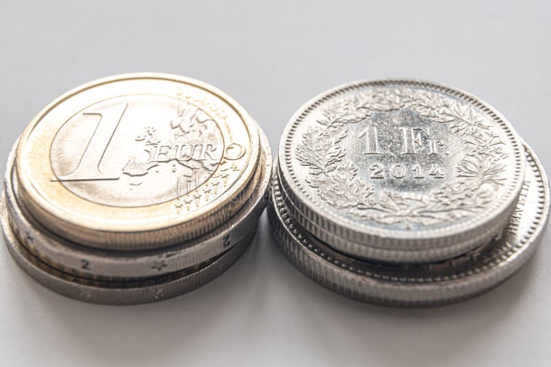 Coins of Euro and Swiss Franc. Conversion between Euro and CHF Stock ...