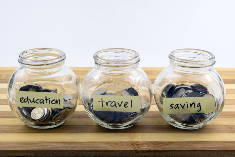 Coins in Glass Containers with Labels on Wood. Stock Photo - Image of ...