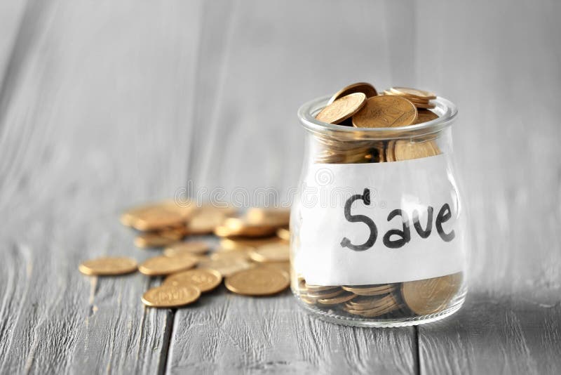 Coins in Glass Jar with Text SAVE on Table. Concept of Savings Stock ...