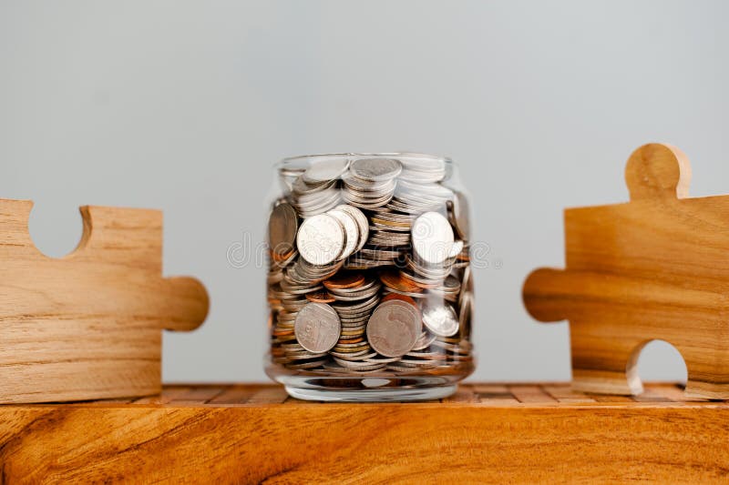 Coins in Glass Jars and Wooden Puzzle Pieces Stock Image - Image of ...