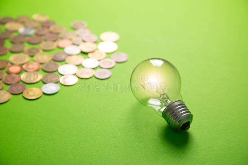 Coins with a Glowing Light Bulb Stock Illustration - Illustration of ...