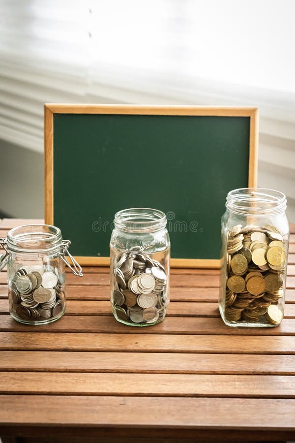 Coins Inside Glass Containers with Chalkboard Stock Image - Image of ...