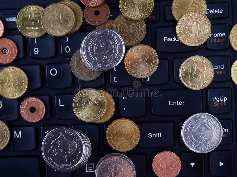 Coins on the Keyboard of a Laptop Computer Stock Photo - Image of ...