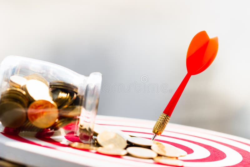 Coins Stack and Darts Arrow Hitting in the Target Center of Dartboard ...