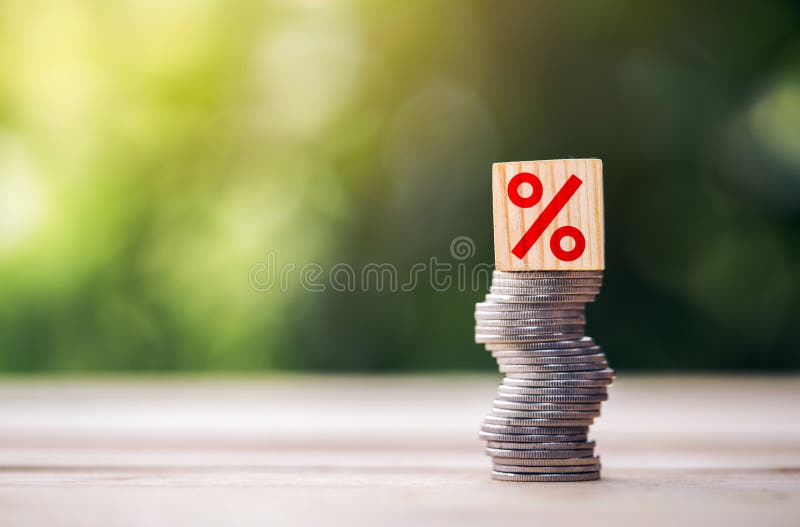 Coins Stacked High on the Table and Wood Block Interest Rate Indicates ...