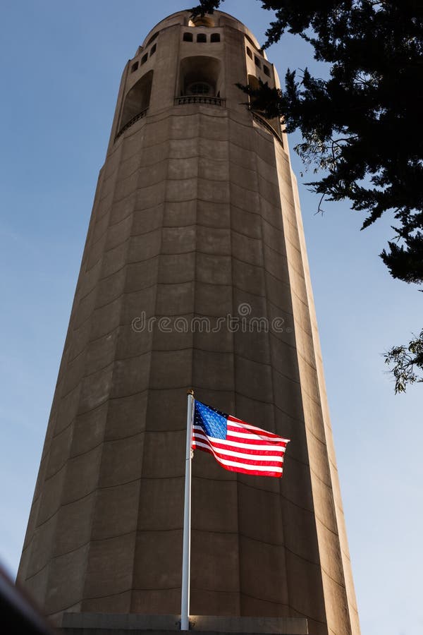 Coit Tower Rises into Blue Sky with American Flag Stock Image - Image ...