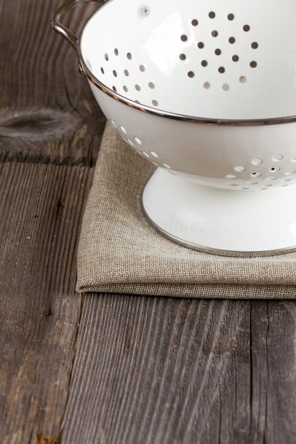 Colander Stands on a Rustic Kitchen Table Stock Image - Image of light ...