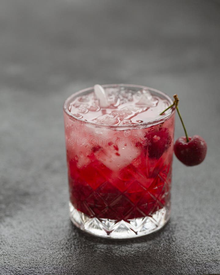 Cold Alcoholic Cocktail with Cherry and Ice Cubes. Cherry Cocktail with ...
