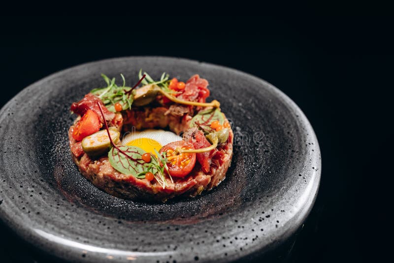 Cold Appetizer Beef Tartare on a Black Background Stock Photo - Image ...