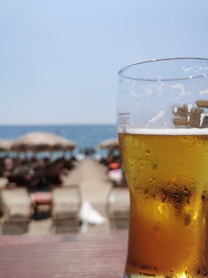 Cold beer beach sun stock image. Image of pint, beach - 216312207