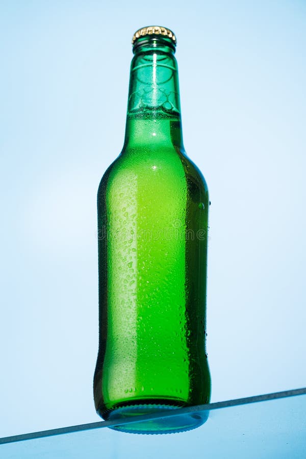 A Cold Beer Bottle Standing on a Glass Table Stock Photo - Image of ...