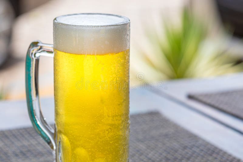 Cold Beer Mug with Foam Isolated on a Table Stock Image - Image of ...