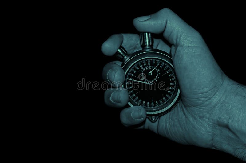 Dark Blue Image of Hand Holding a Mechanical Stopwatch on Black ...