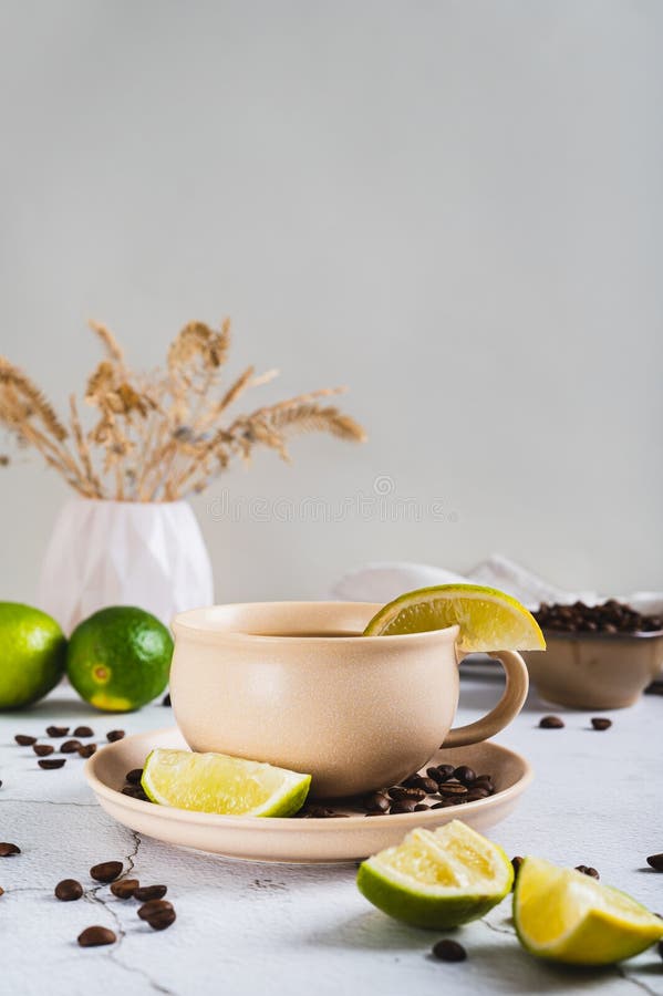 Cold Coffee with Lime Wedges in a Cup on the Table Vertical View Stock ...