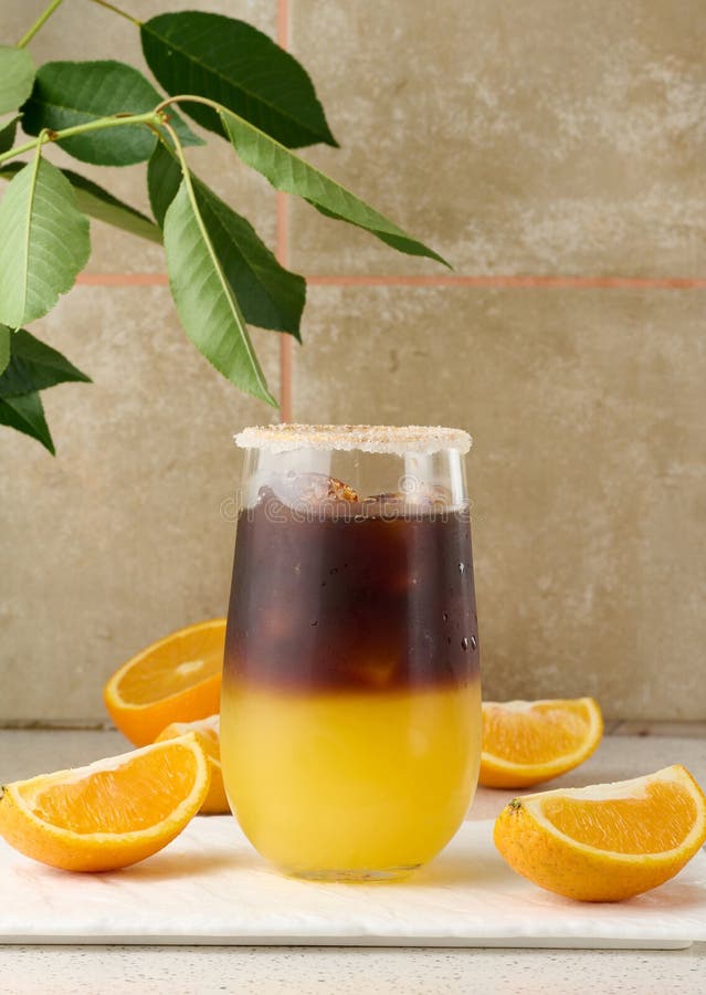 Cold Coffee with Orange Juice in a Transparent Glass and Orange Slices ...