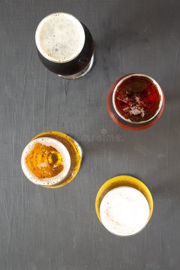 Cold Craft Beer Assortment on a Black Surface, Top View. Overhead, from ...