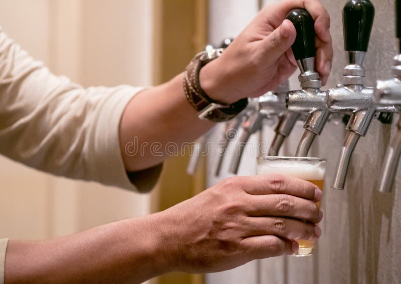 Cold Draft Beer Poured into Glass from Silver Beer Dispenser, Selective ...