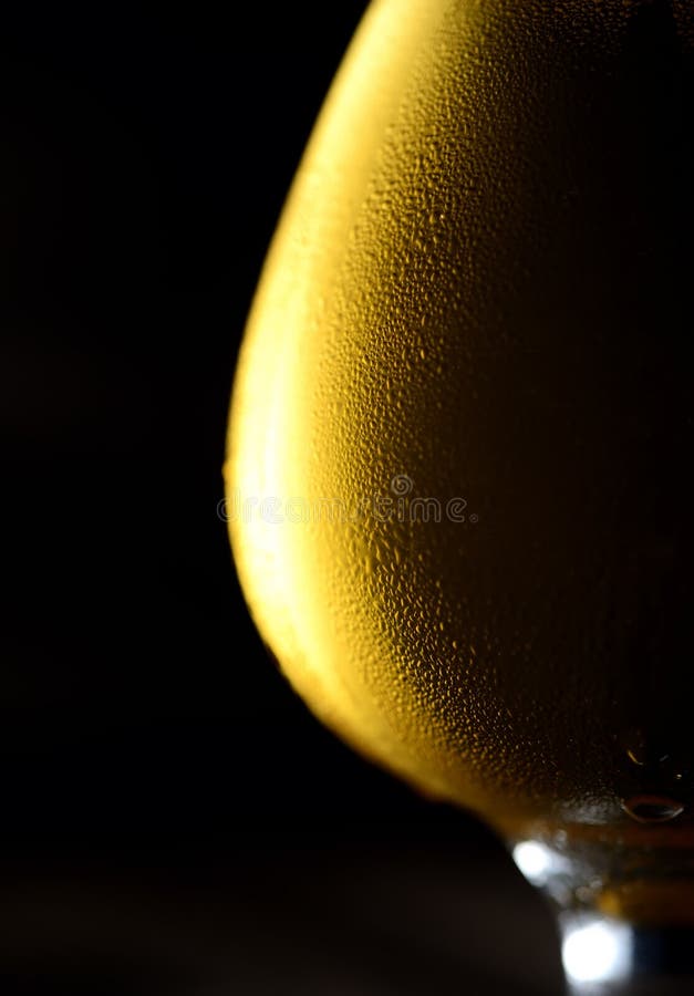Cold Frothy Beer in a Glass of Original Color on a Black Background ...