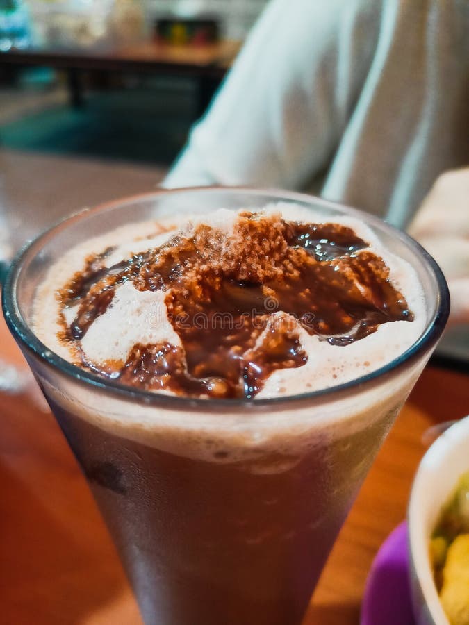 Cold Ice Milkshake with Chocolate Syrup Topping on Top Stock Photo ...